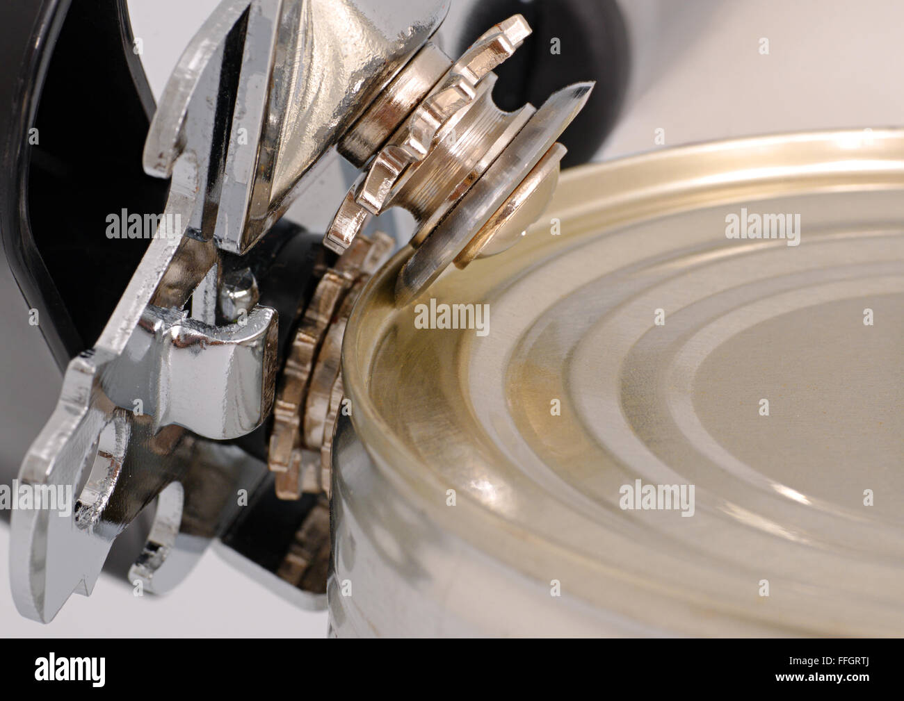 Automatic can opener opens a can Stock Photo - Alamy