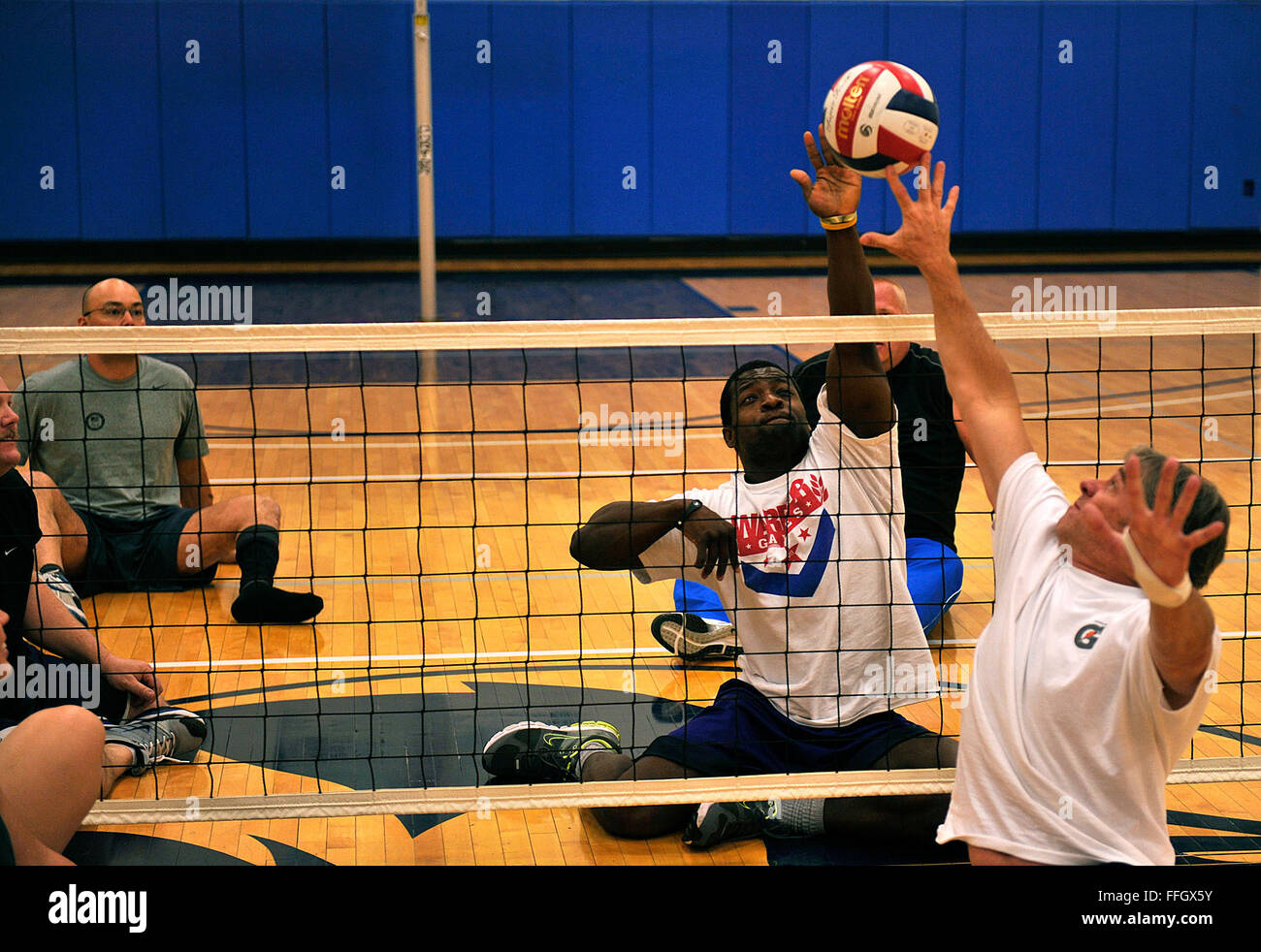 Former Staff Sgt. Matt Sanders (third from right) tries to block a shot ...