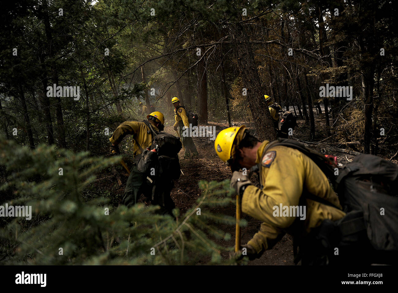 Firefighters from the Vandenberg Hot Shots cut a fire break line in the ...