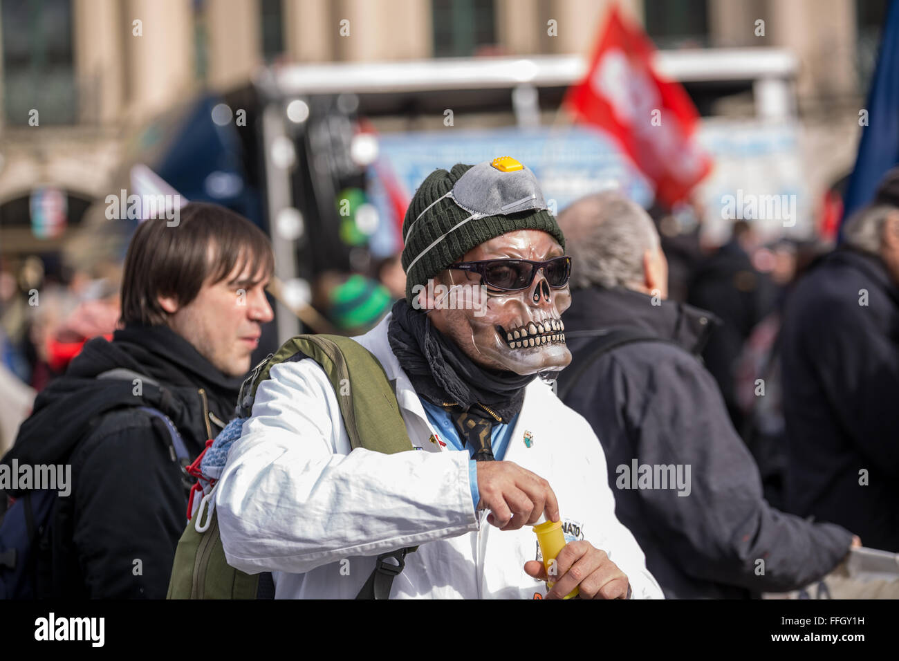 Munich, Germany. 13 Feb, 2016. A demonstrator with a skull mask. Credit ...