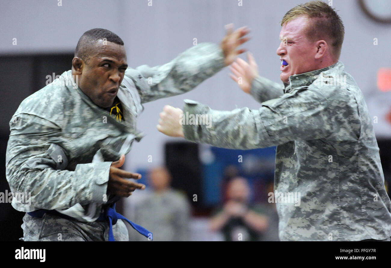 Army 1st Lt. Daniel Midgett (right) exchanges open-handed strikes with ...