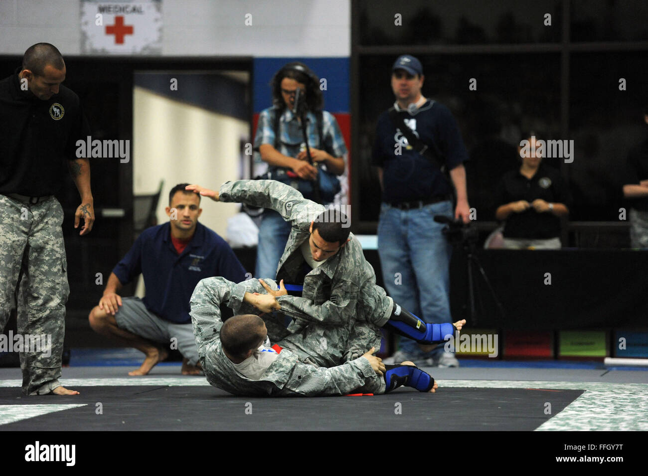 Staff Sgt. Samuel Aguilar (top) prepares to strike Army Spc. Karl ...