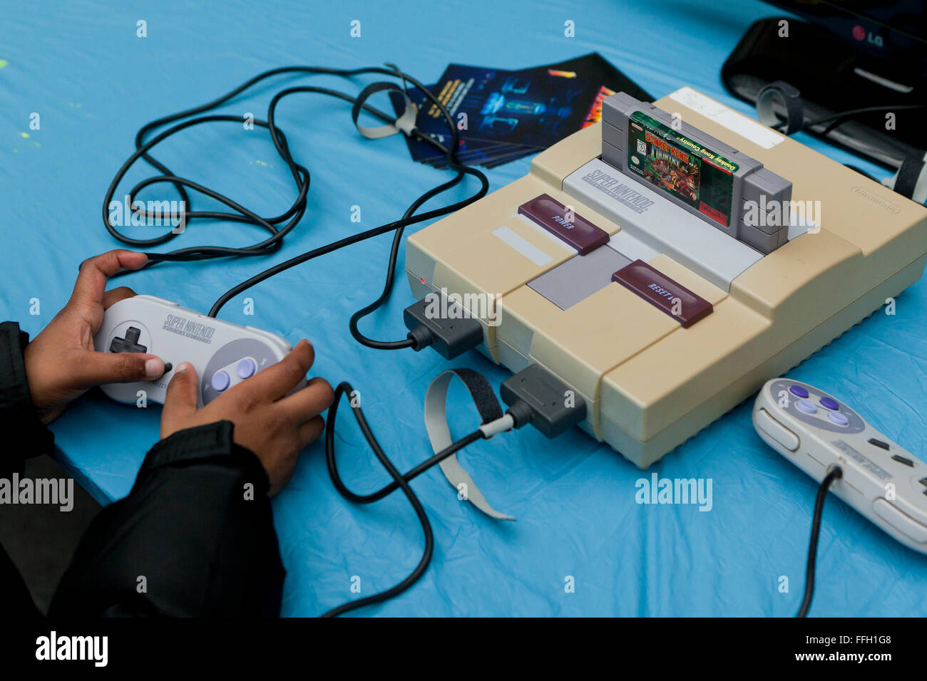 Child playing Donkey Kong Country on Super Nintendo Entertainment ...