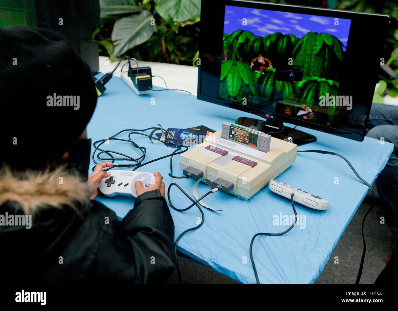 Child playing Donkey Kong Country on Super Nintendo Entertainment ...