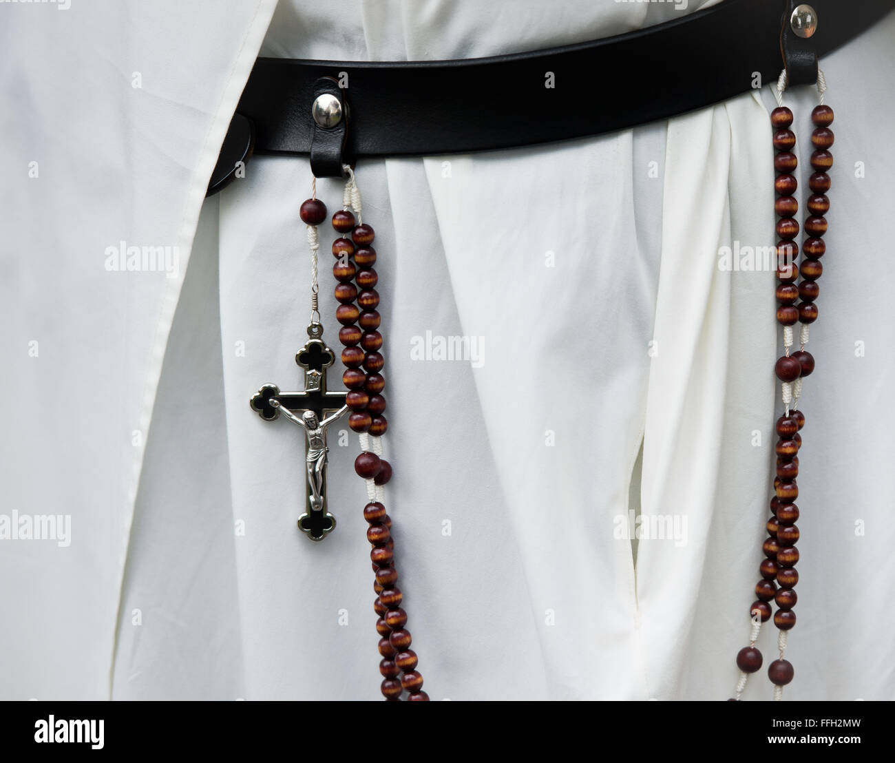 Rosary beads hang from the hip of Father James Sullivan. Sullivan is ...