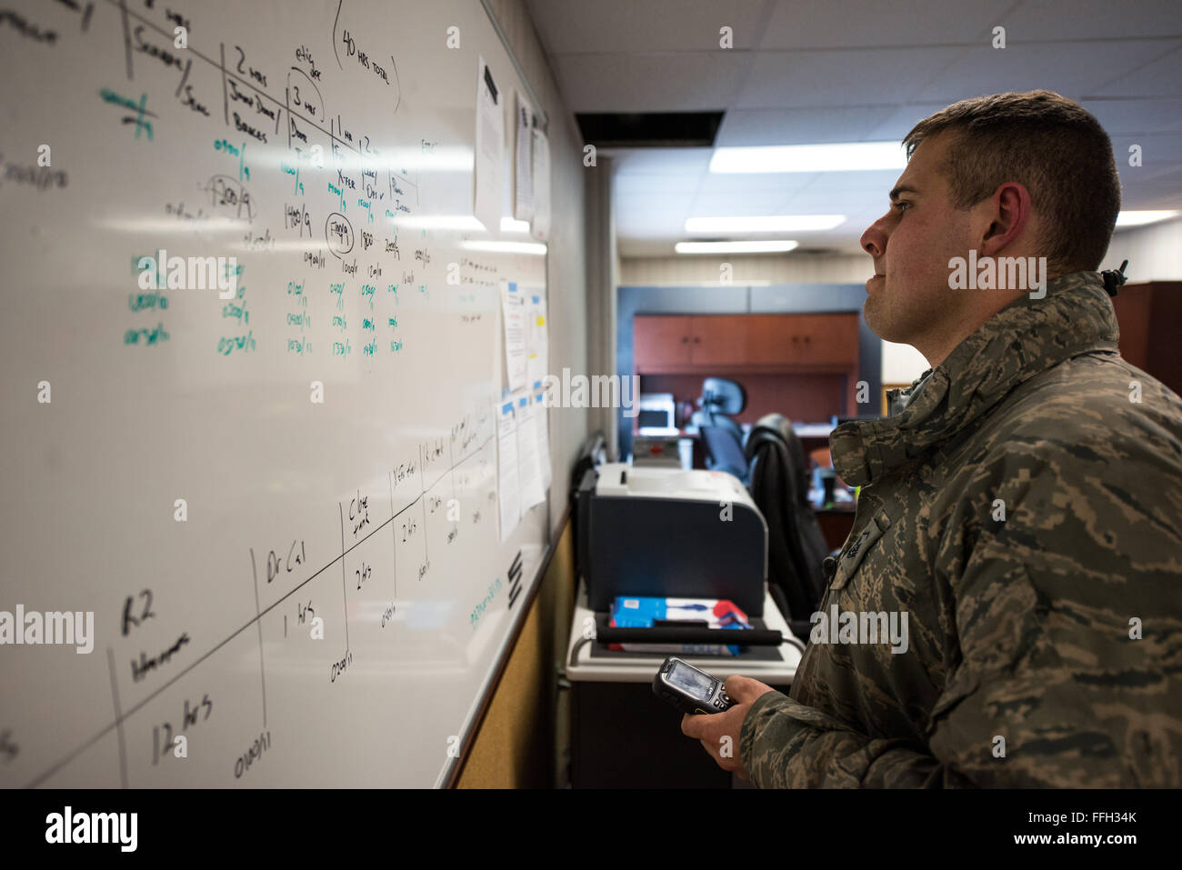 Master Sgt. Randy Rollins looks over the projected times of each phase ...