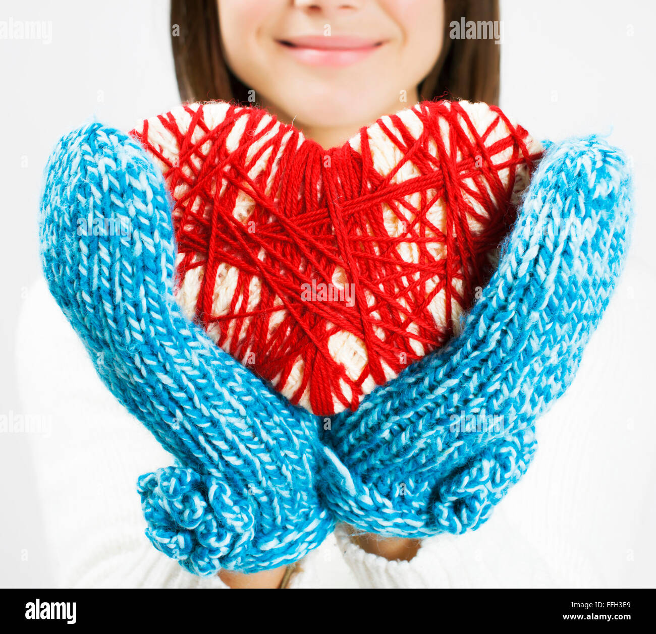 Girl hands in blue knitted mittens holding romantic red heart Stock ...