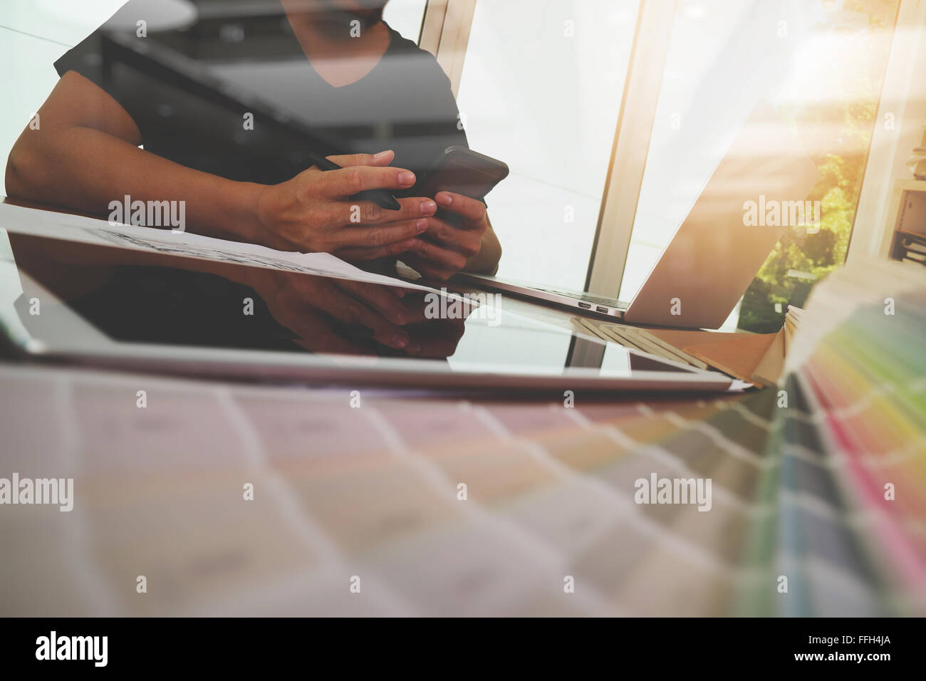 Designer hand working with laptop computer and smarth phone and digital ...