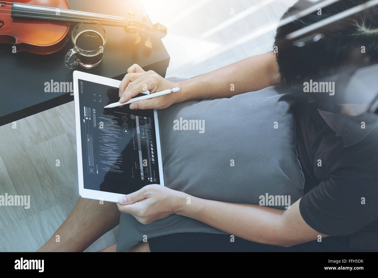 hipster hand composing music with digital tablet compter and sitting on ...