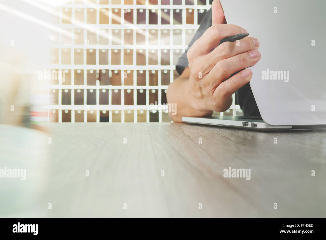 interior designer hand working with laptop computer and sample material ...