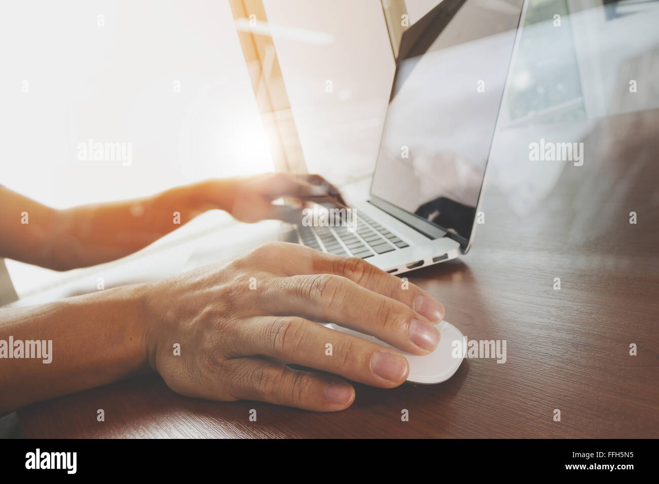 business man hand working on blank screen laptop computer on wooden ...