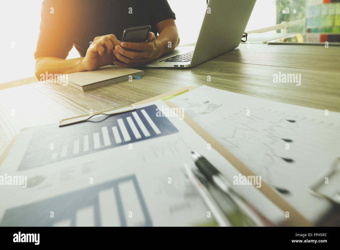 Designer hand working with laptop computer and smarth phone and digital ...