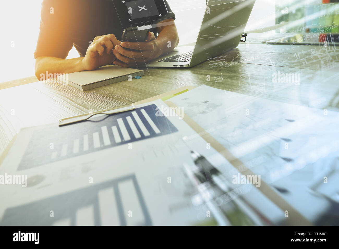 Designer hand working with laptop computer and smarth phone and digital ...