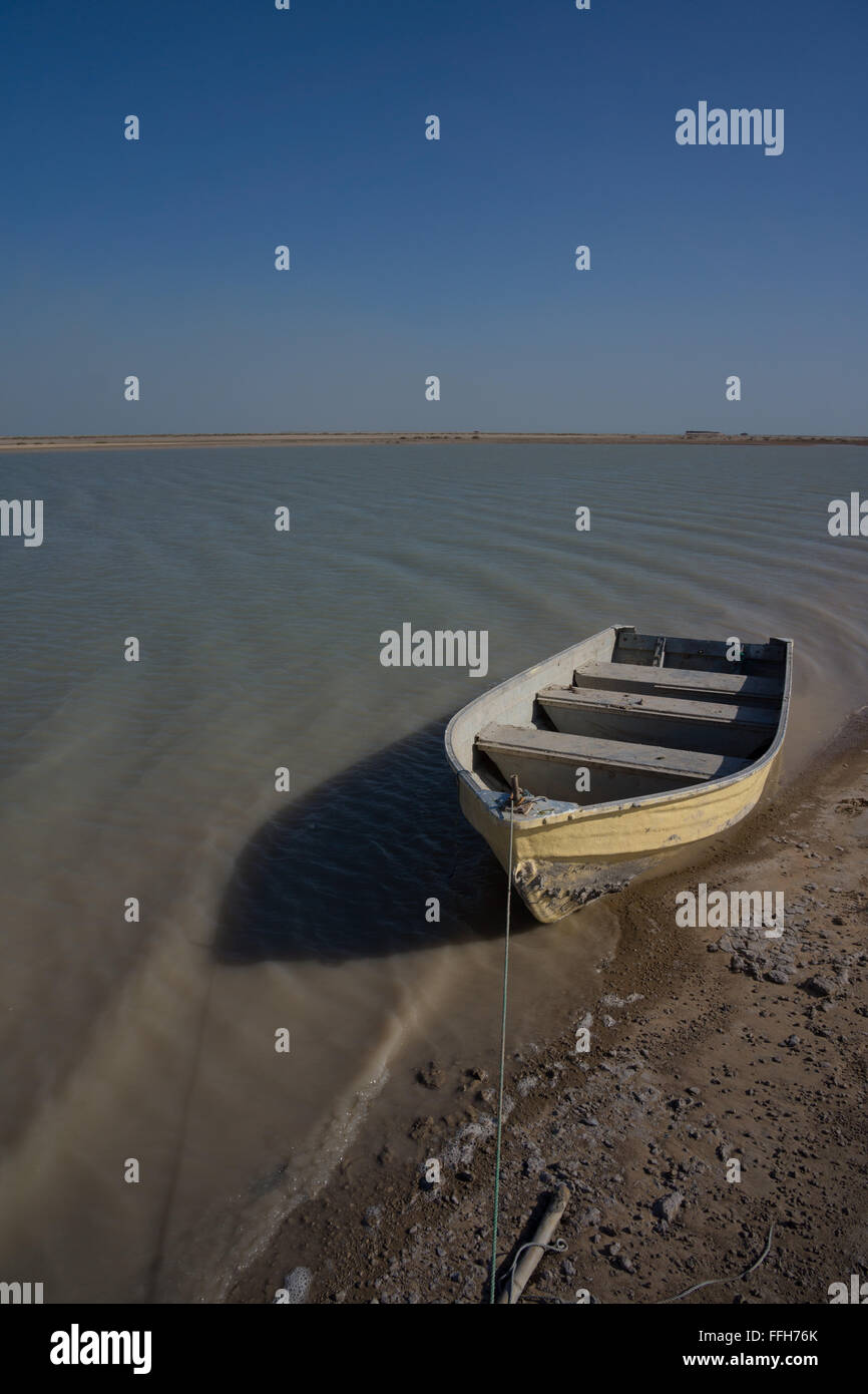 Small wooden boat in desert estuary Stock Photo - Alamy