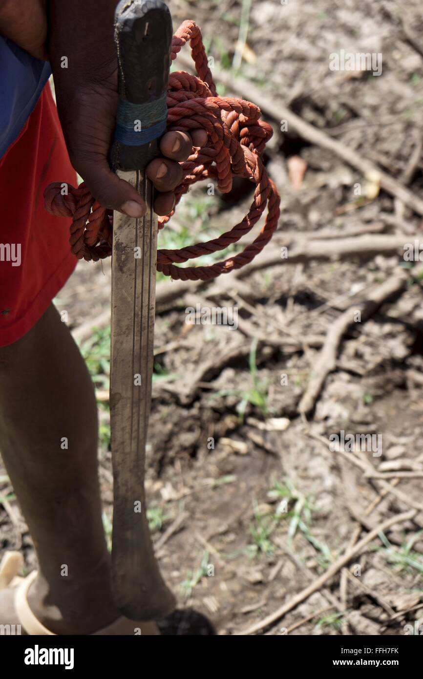 Detail of a boy holding a machete behind his back Stock Photo - Alamy