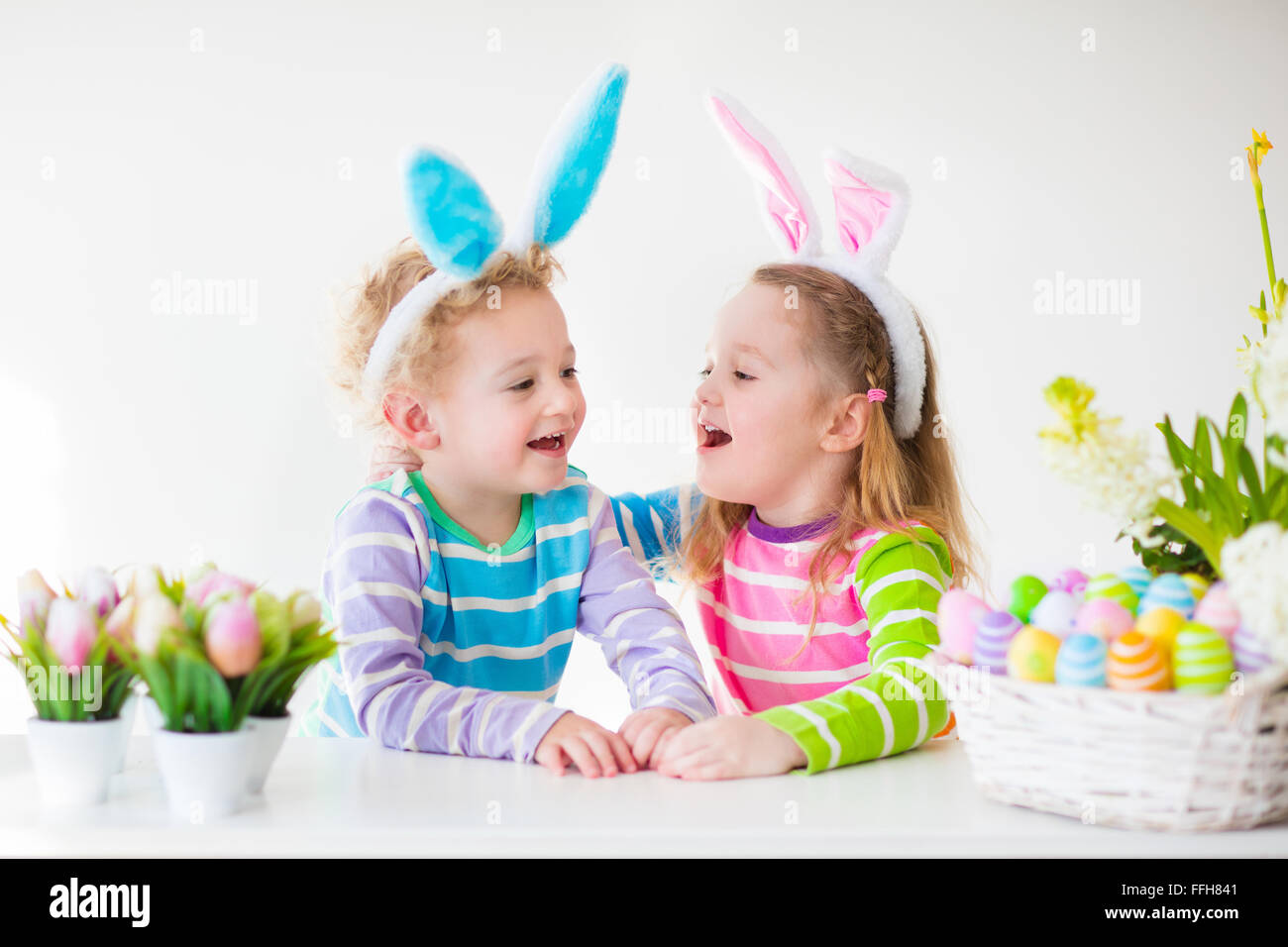 Happy children celebrate Easter at home. Boy and girl wearing bunny ...