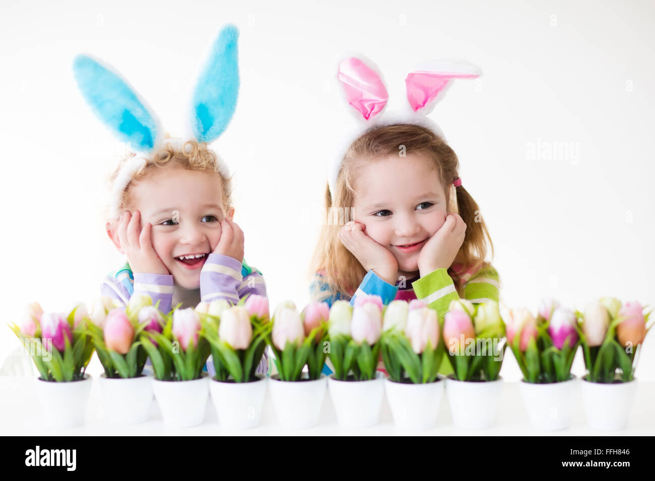 Happy children celebrate Easter at home. Boy and girl wearing bunny ...