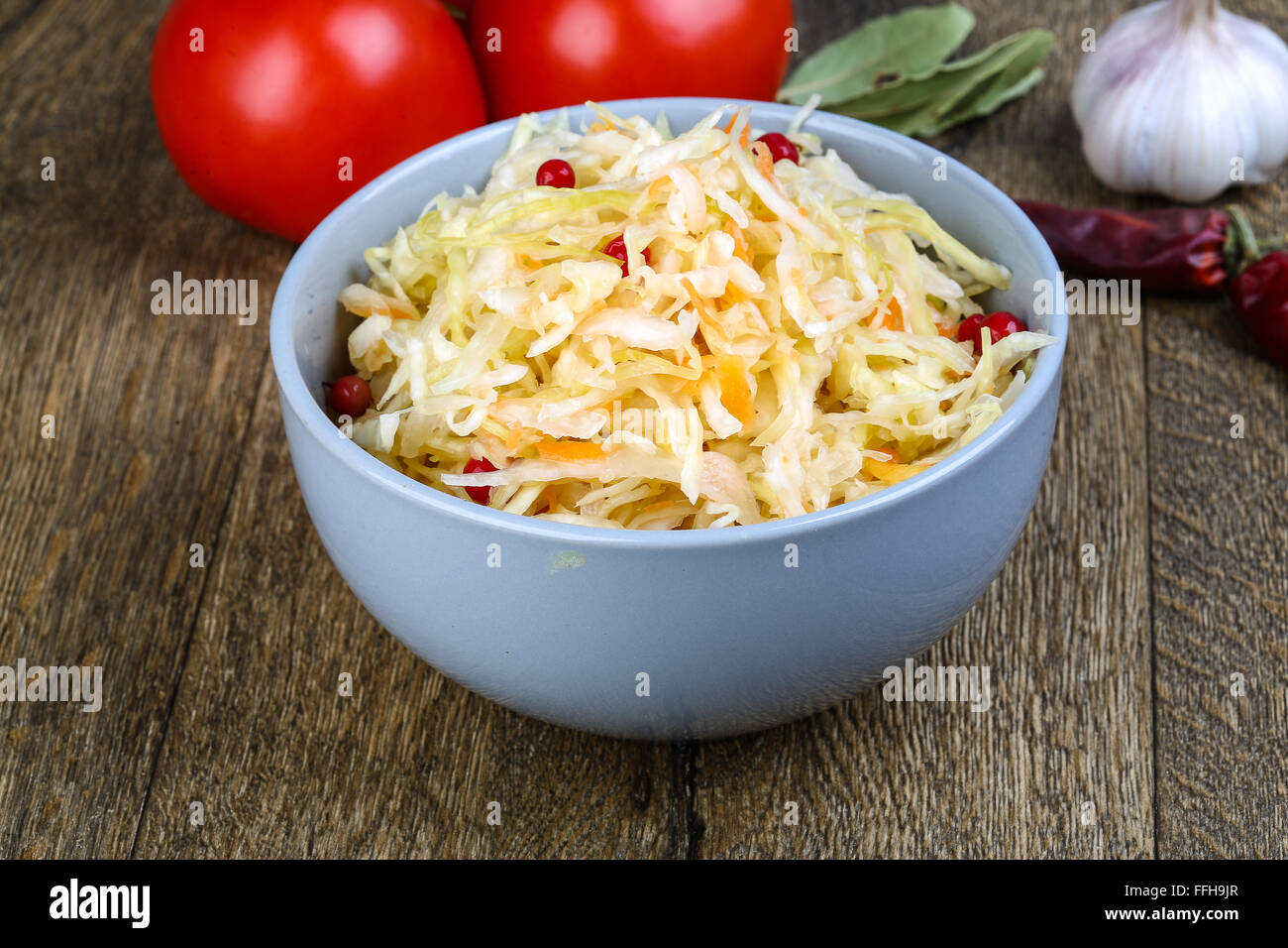 Fermented cabbage - Sauerkraut with herbs and spices on the wood ...