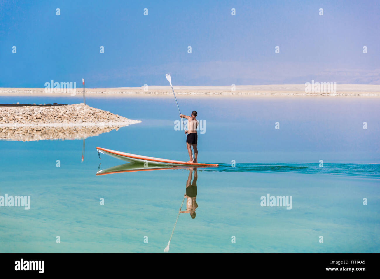 man floats on a boat in the dead sea Stock Photo - Alamy