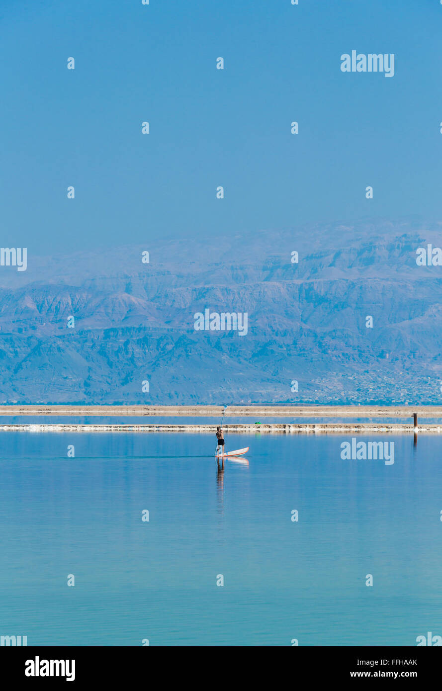 man floats on a boat in the dead sea Stock Photo - Alamy