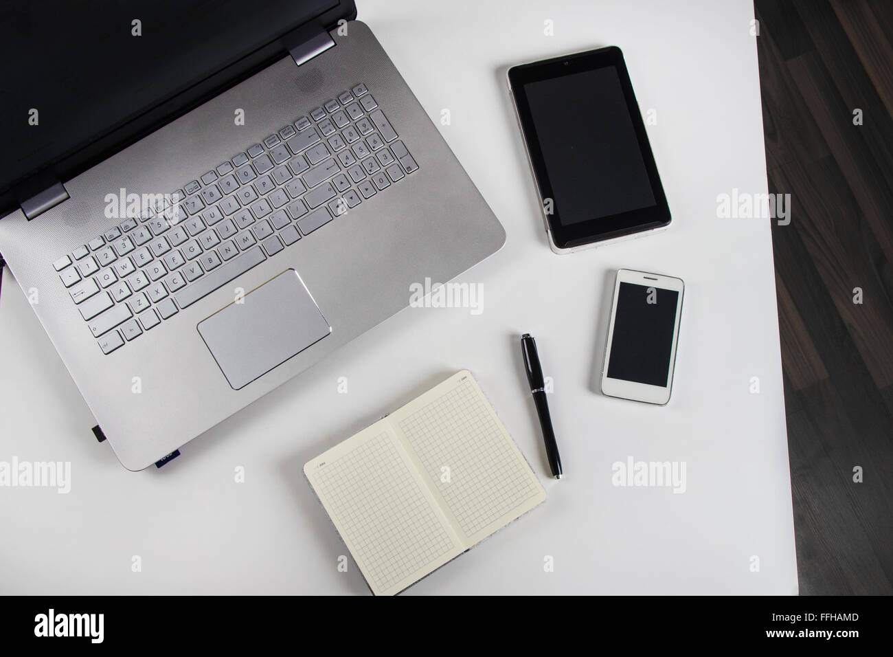 table with laptop and notebook Stock Photo - Alamy