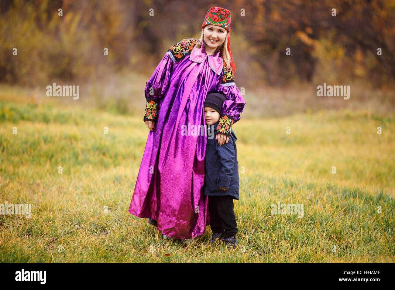 Family portrait of mother with her son outdoors in traditional national ...