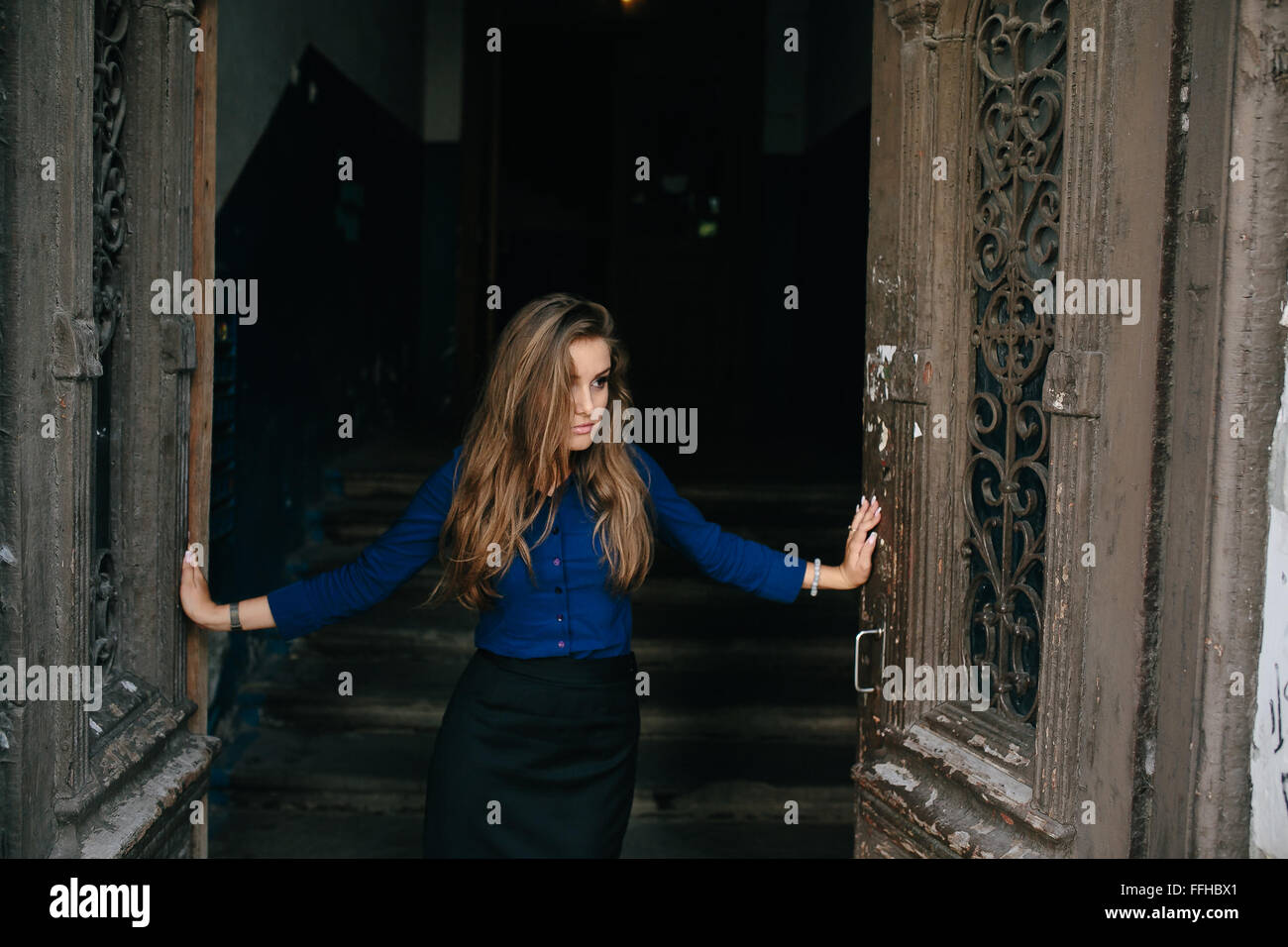 beautiful model opens an old door Stock Photo - Alamy