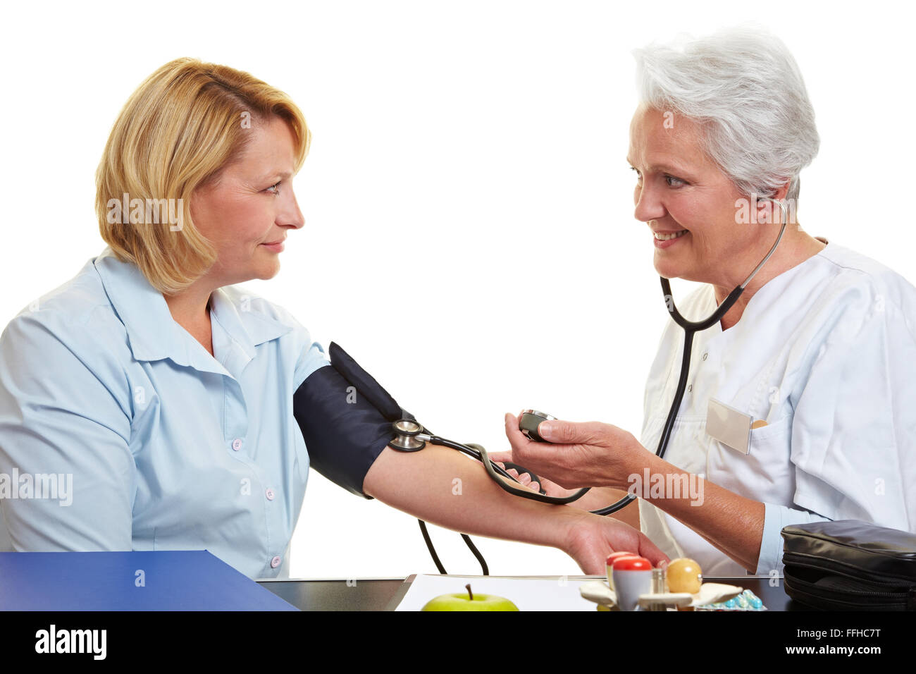 Elderly doctor with blood pressure meter on patient Stock Photo - Alamy