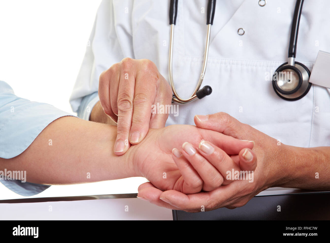 Doctor hands feeling pulse on female wrist Stock Photo - Alamy
