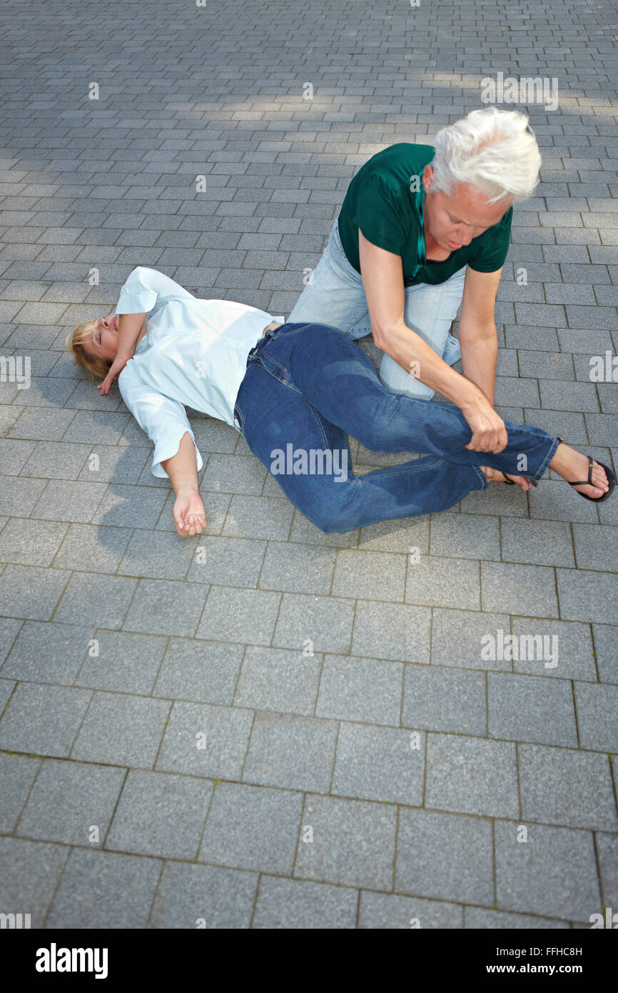 Senior woman using recovery position on unconscious woman Stock Photo ...