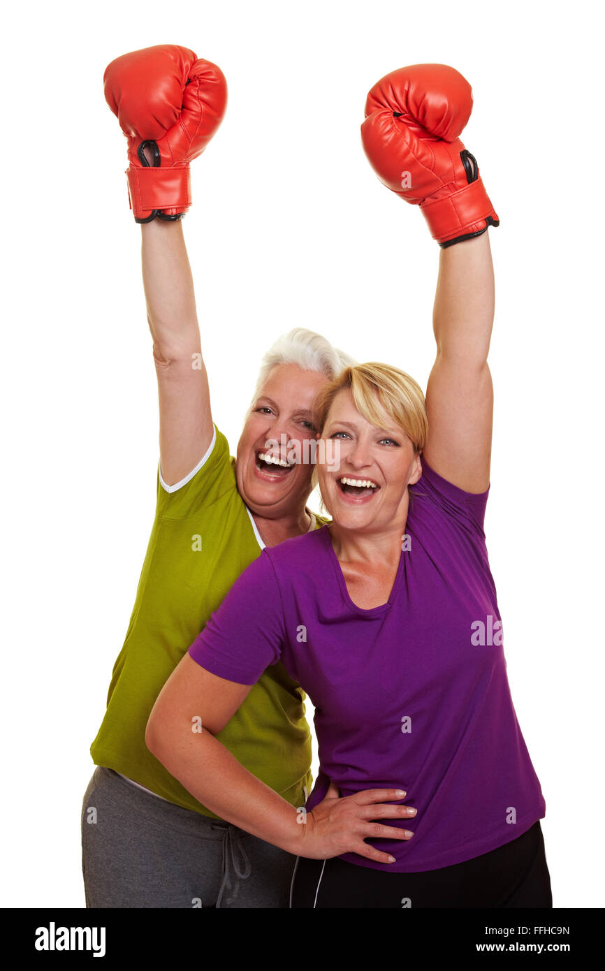 Two happy women cheering with red boxing gloves Stock Photo - Alamy
