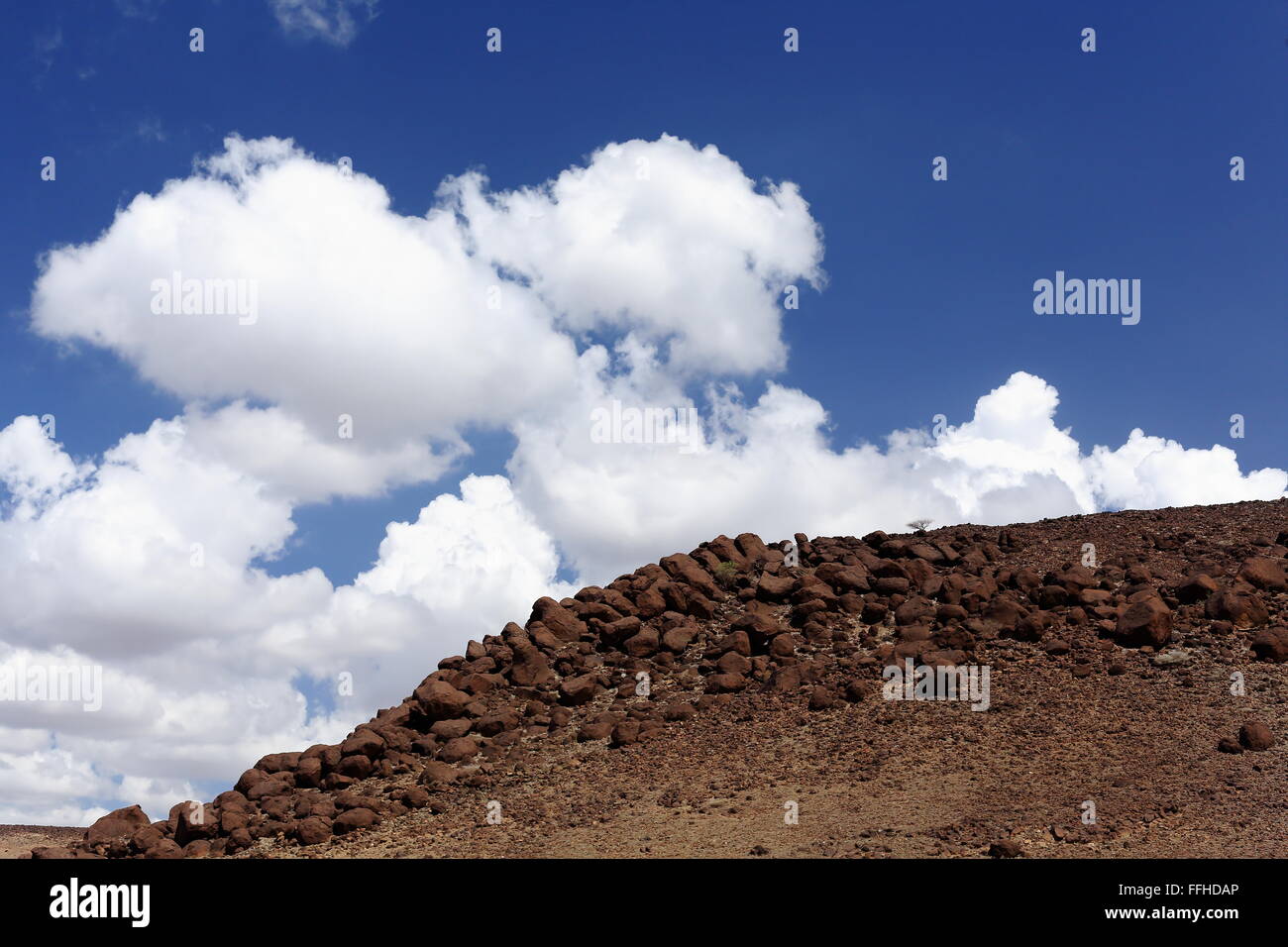 Cumulus clouds-volcanic stones-Awash river valley. From the Awash-Asseb ...