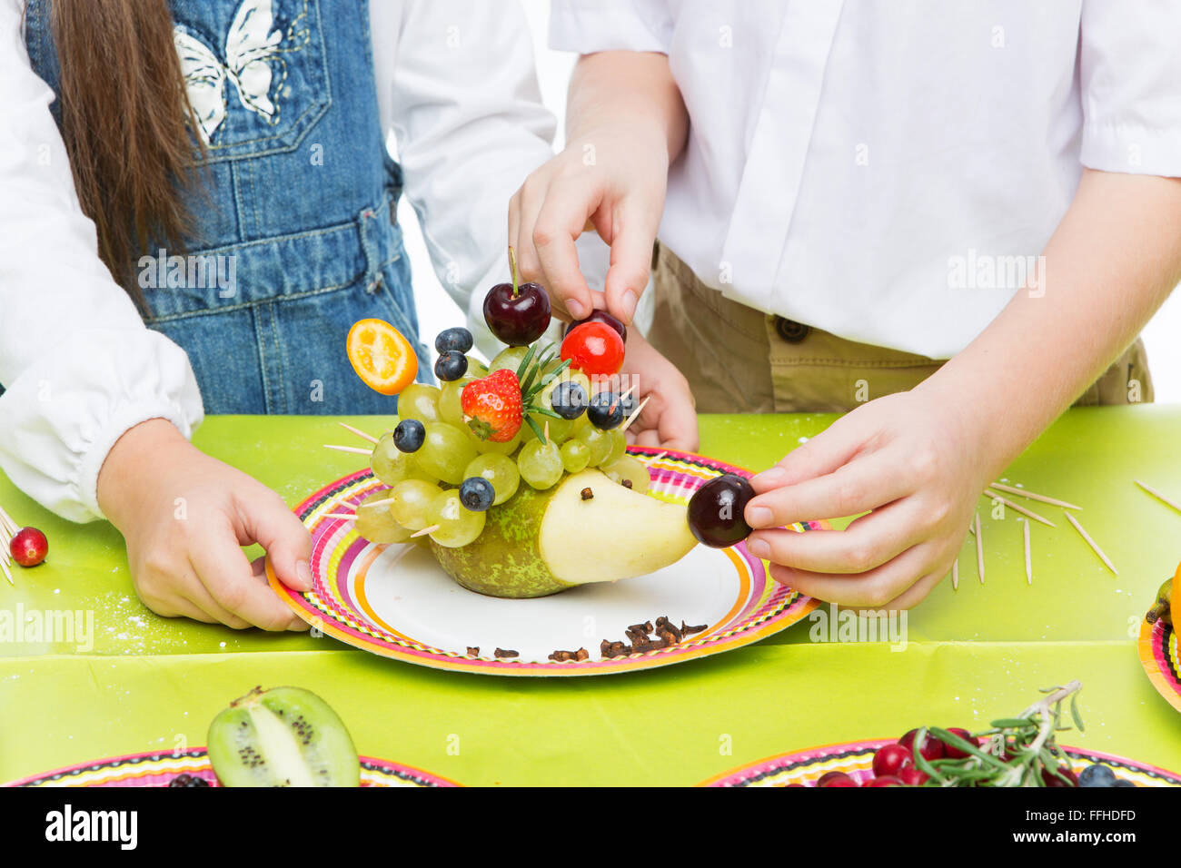 Children making fruit hedgehog Stock Photo - Alamy