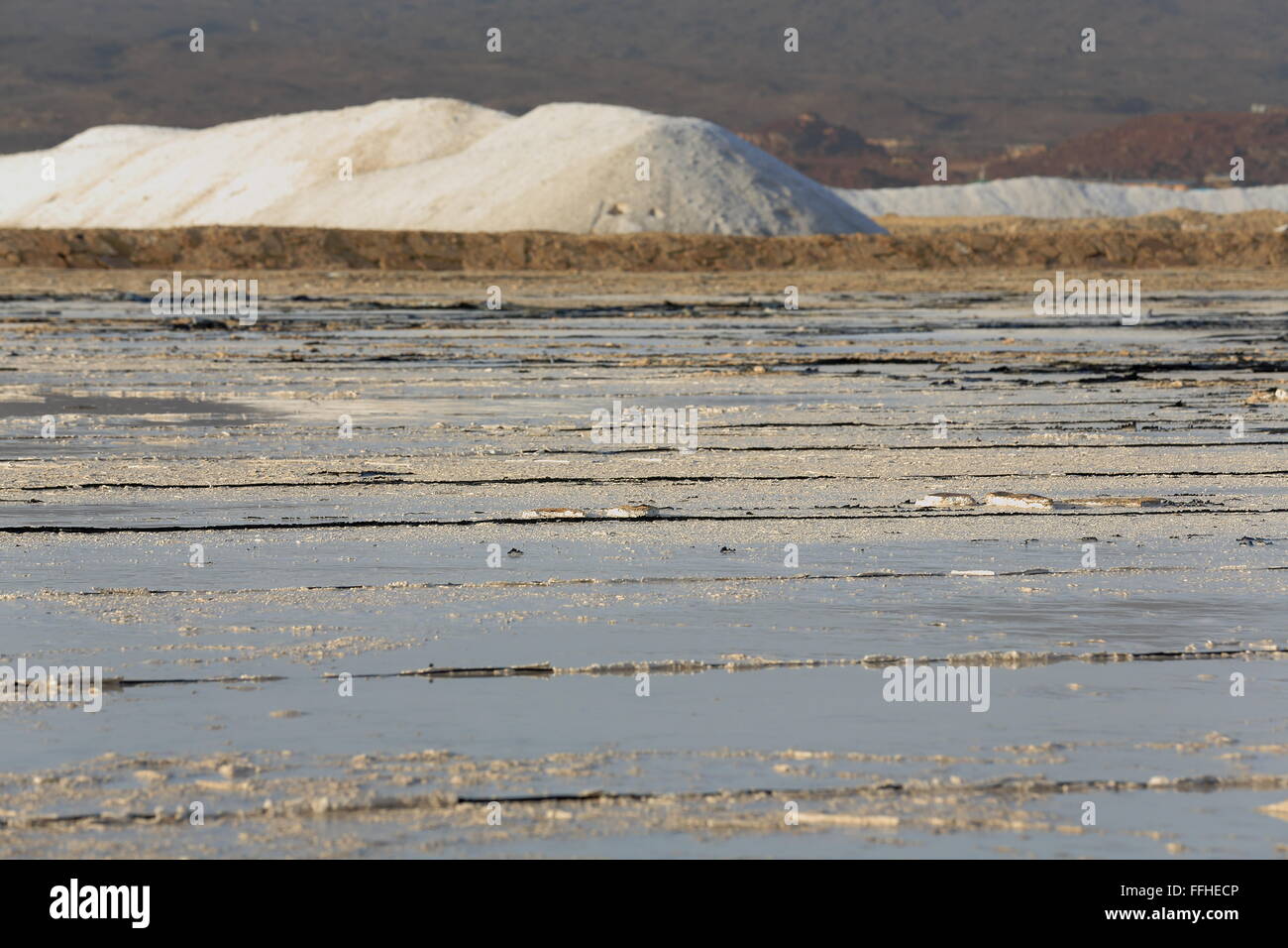 Rusty old wheelbarrow-artificial pond for water evaporation-salt mound ...