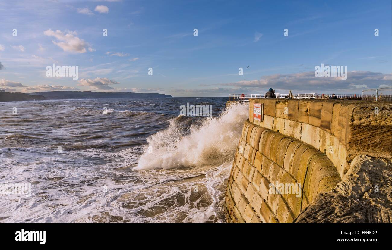 Breaking wave crashing through gap in a pier Stock Photo - Alamy