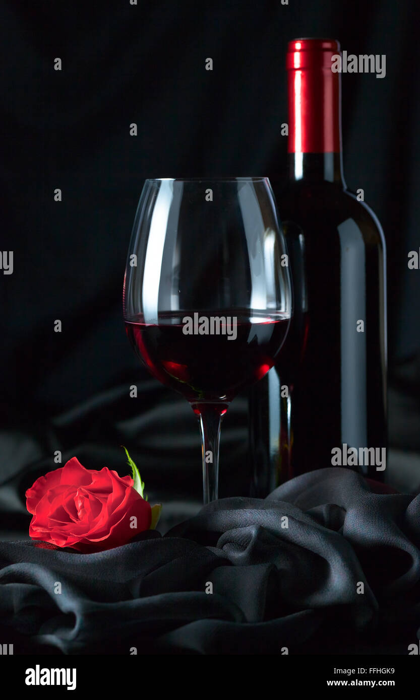 red rose and red wine on black background Stock Photo - Alamy
