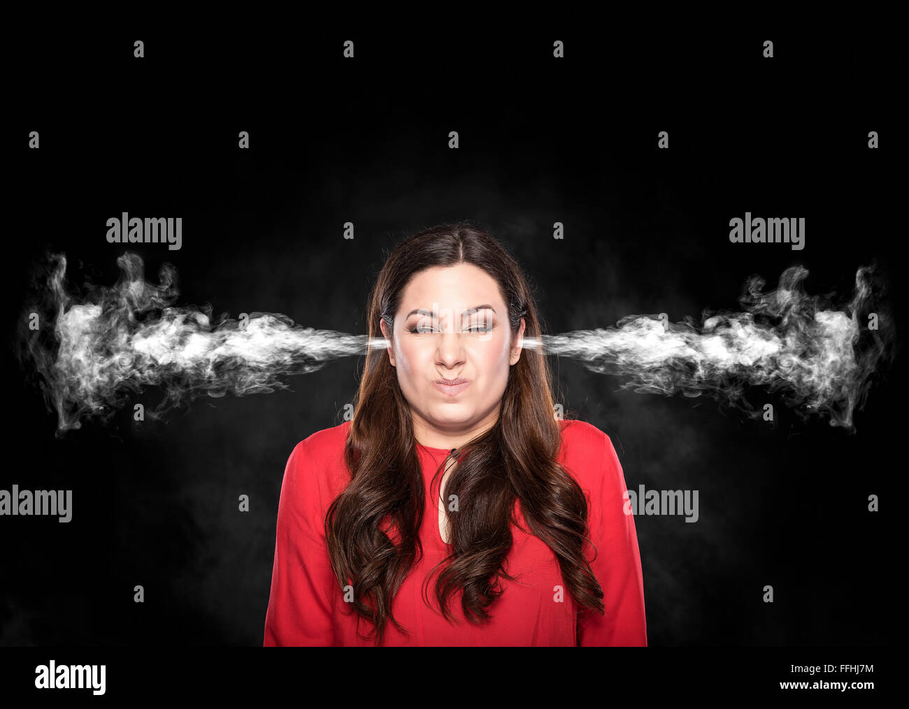 Smoke from the ears of a woman over dark background Stock Photo - Alamy
