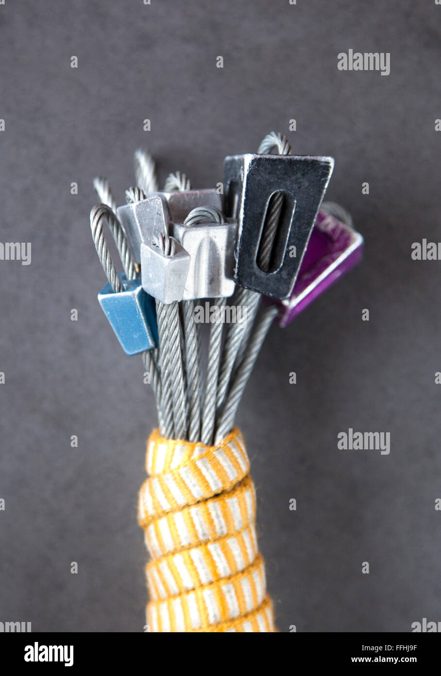 Set of climbing nuts tied up with a strap Stock Photo - Alamy