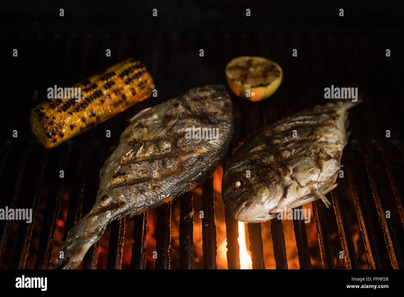 Grilled dorado with vegetables preparing Stock Photo - Alamy