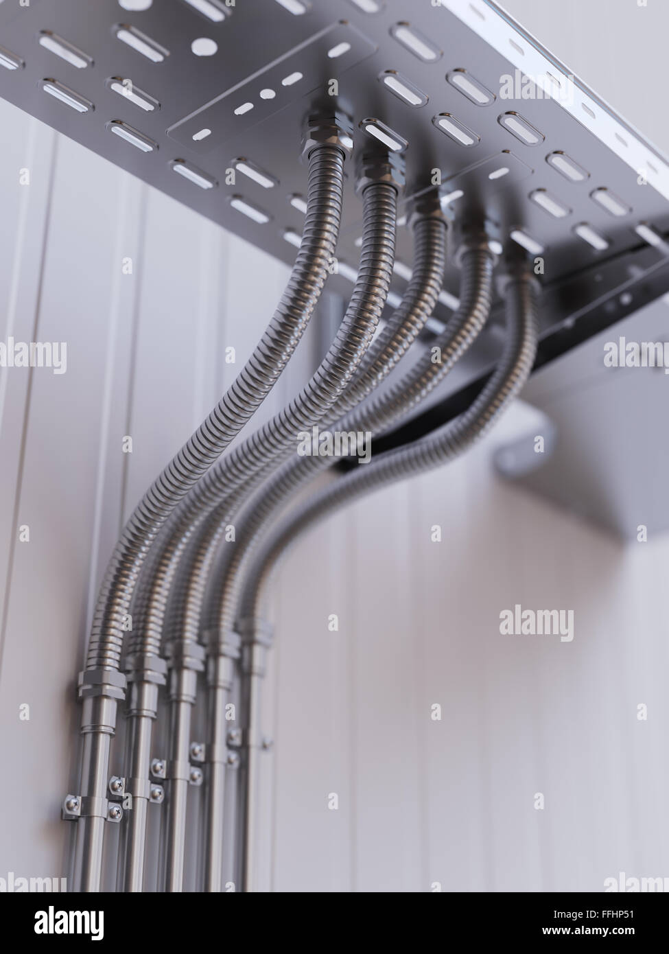Metal pipes with flexible part and cable tray inlet mounted on a wall ...