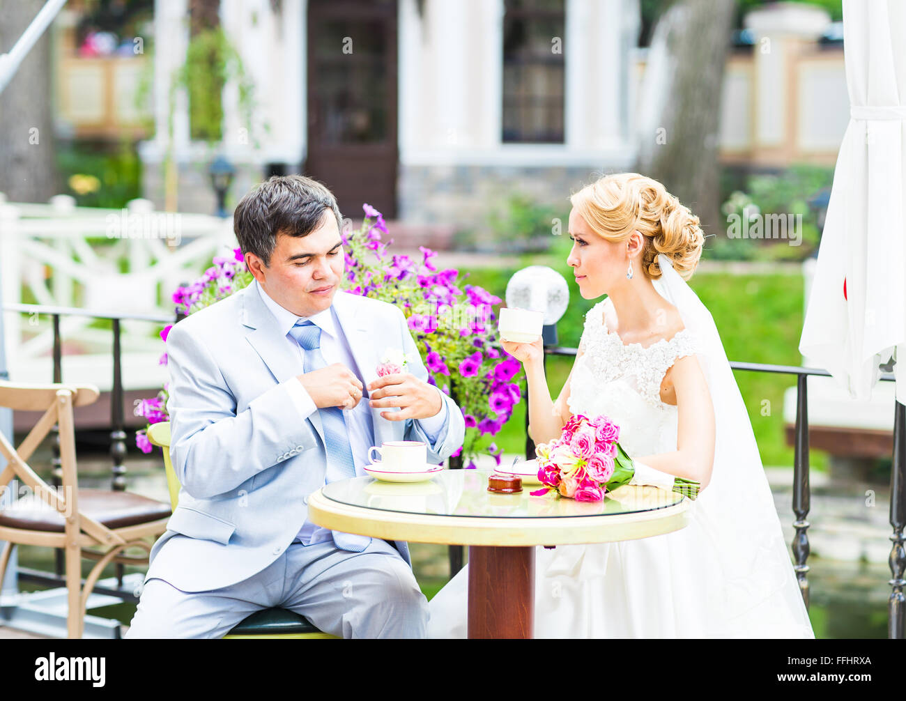 Bride and groom drinking coffee at an outdoor cafe Stock Photo - Alamy