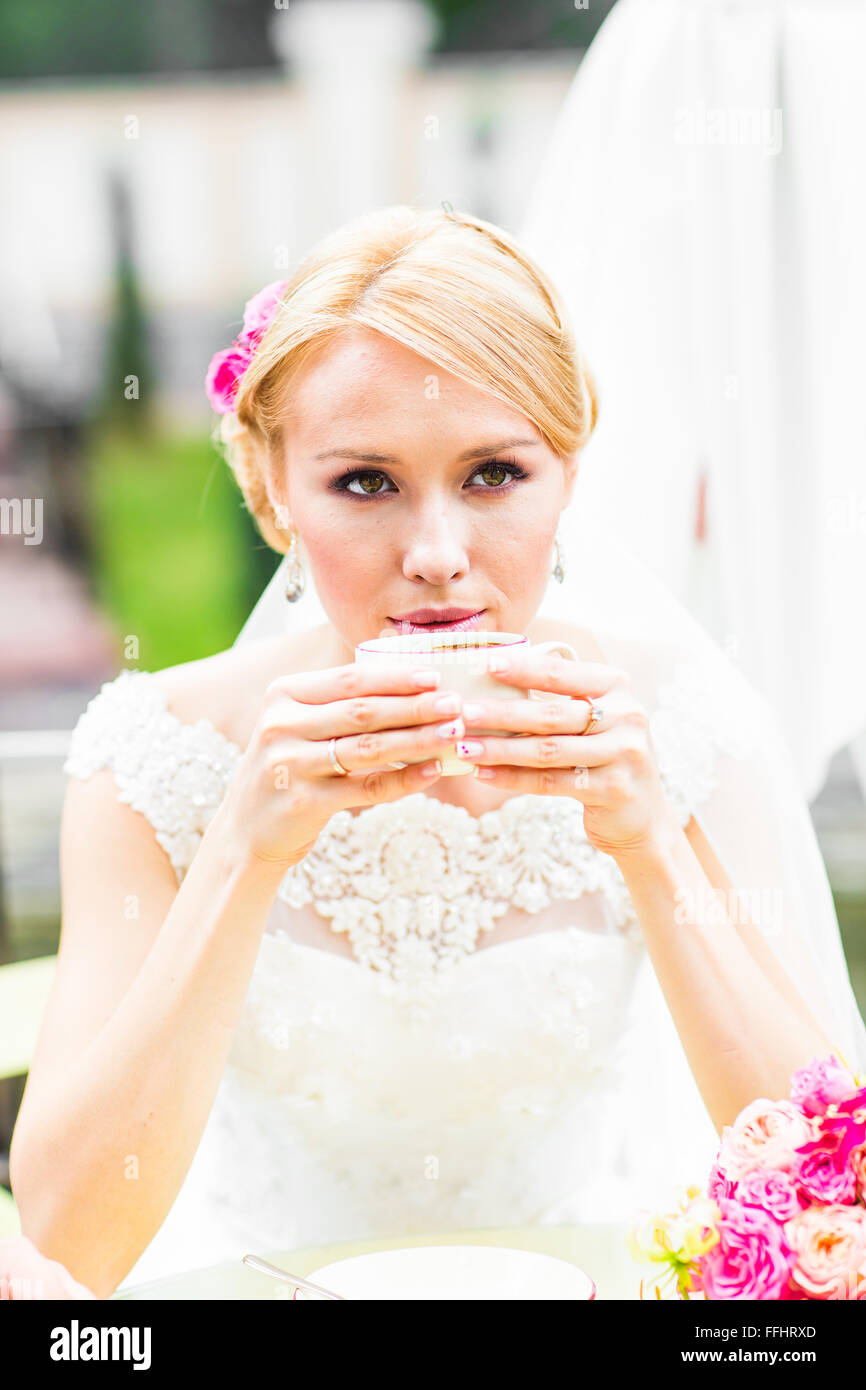 Bride drinking coffee at an outdoor cafe Stock Photo - Alamy