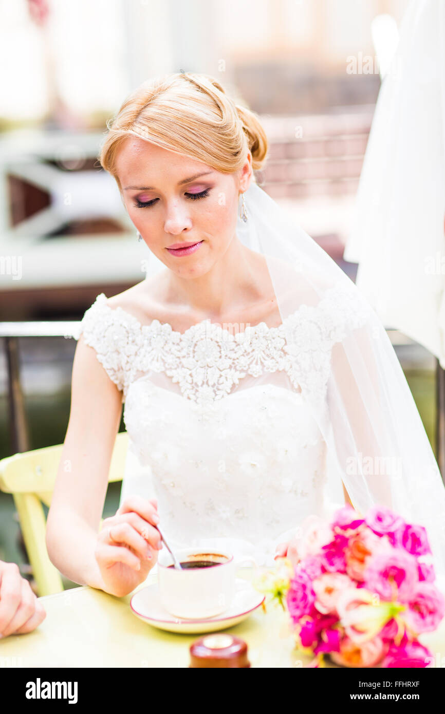 Bride drinking coffee at an outdoor cafe Stock Photo - Alamy