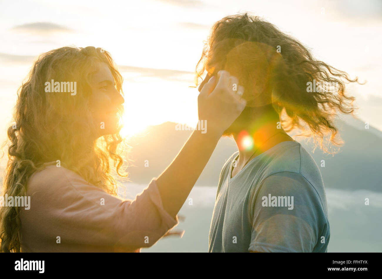 Happy couple in the sun on a background of mountains. stock image Stock ...