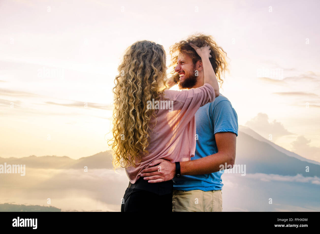 Happy couple in the sun on a background of mountains. stock image Stock ...