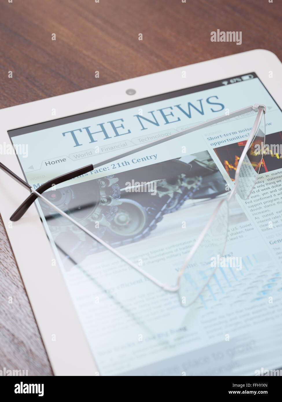 Tablet PC with newspaper application and glasses Stock Photo - Alamy