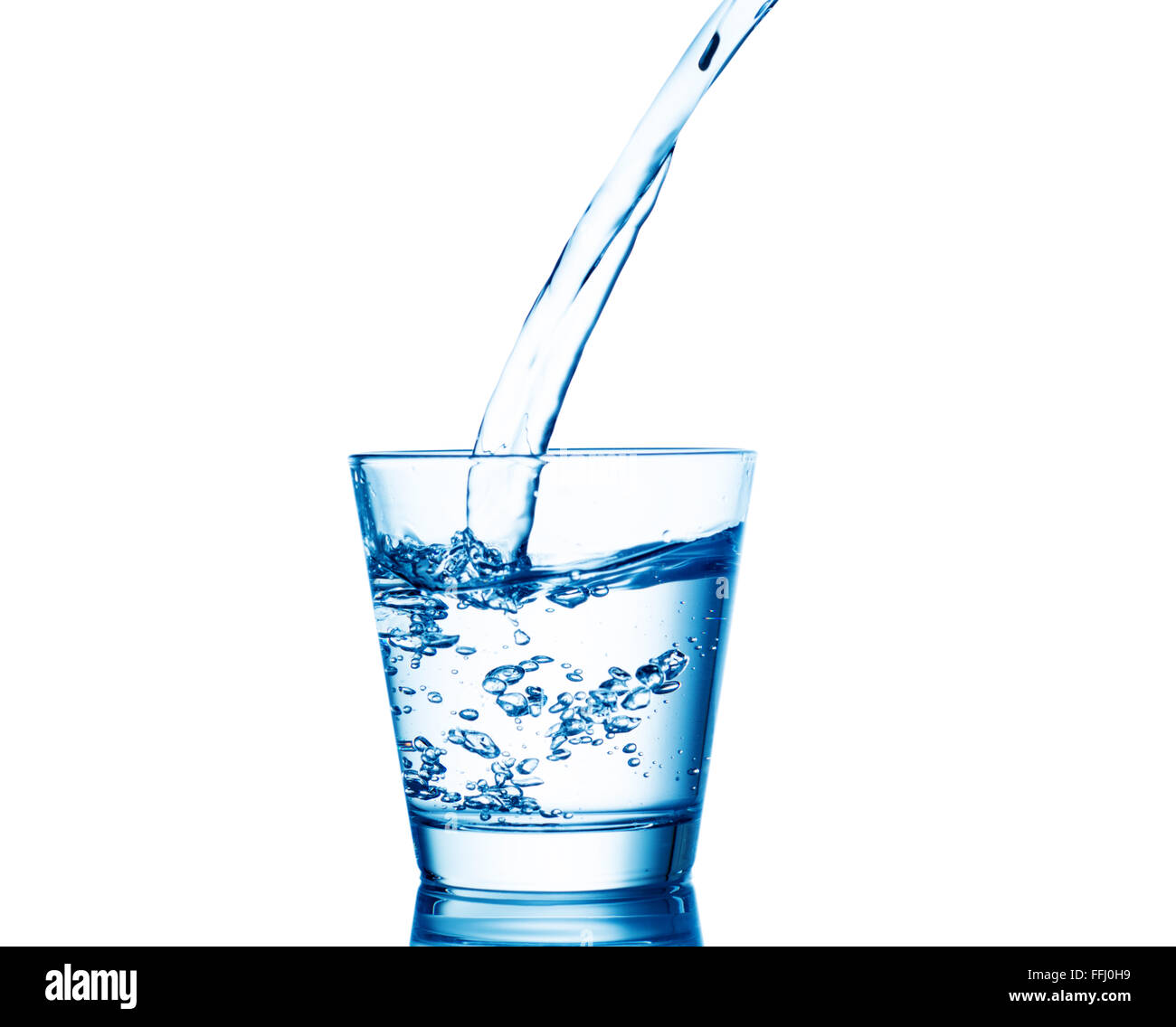 pouring water on a glass isolated onwhite background Stock Photo - Alamy