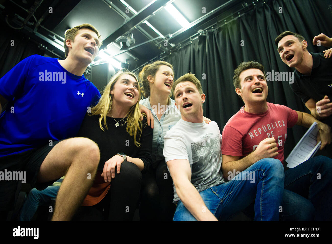 A group of young professional actors in a rehearsal room, rehearsing a ...