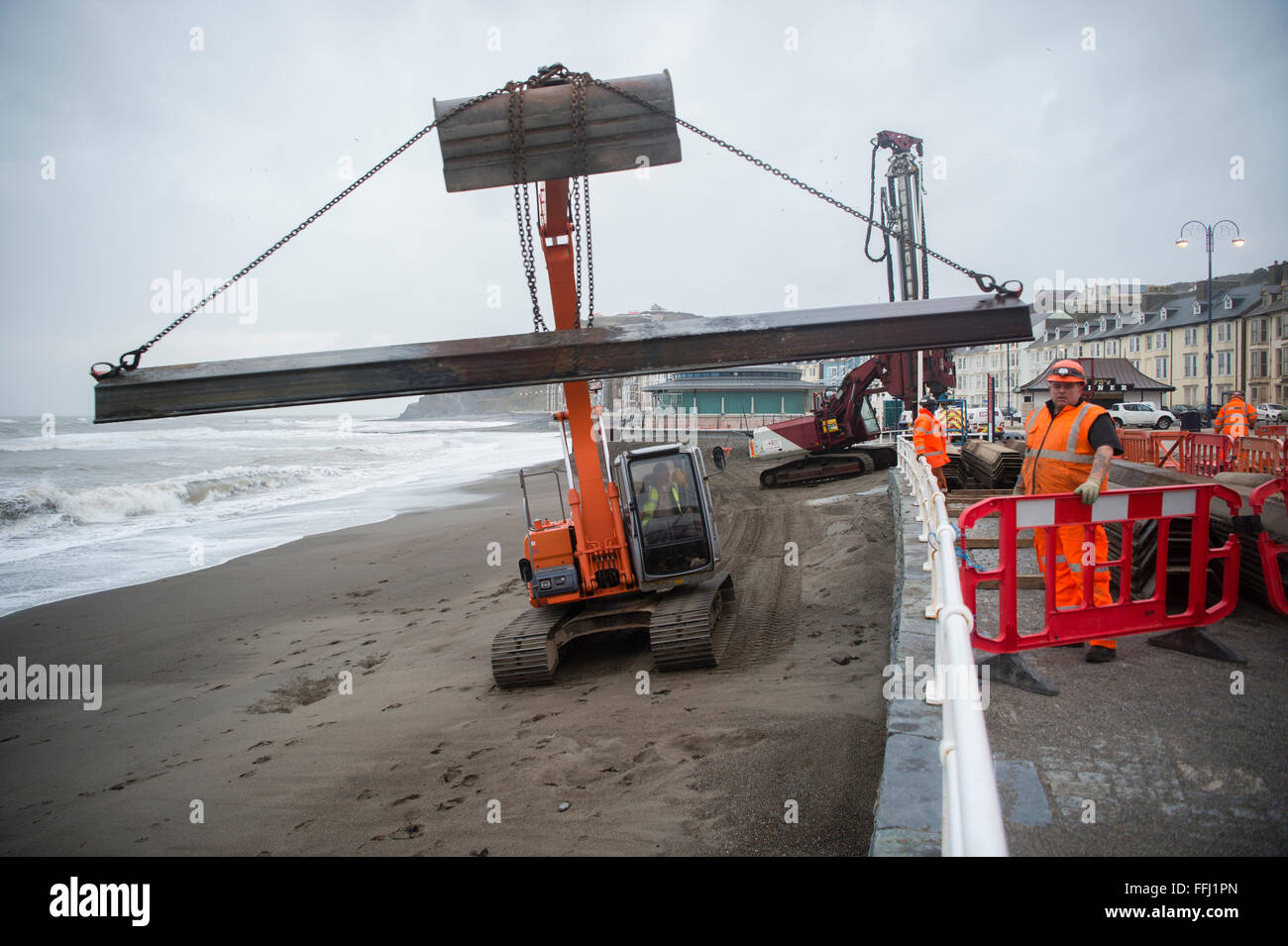 Construction workers removing the steel protective barrier from around ...