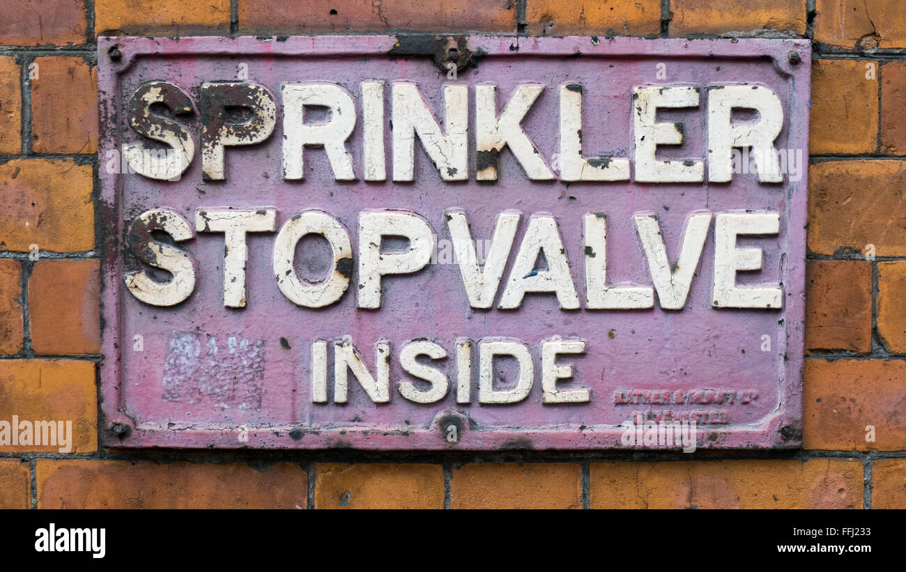 Old sign saying 'Sprinkler Stop Valve Inside' Stock Photo - Alamy